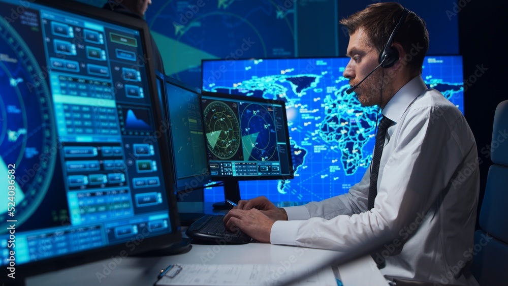 Workplace of the air traffic controllers in the control tower. Team of ...