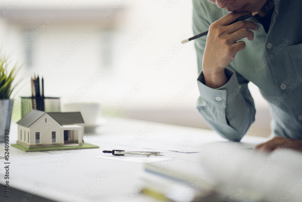 Architect Design Concept, Asian engineer work on Blueprint Construction ...