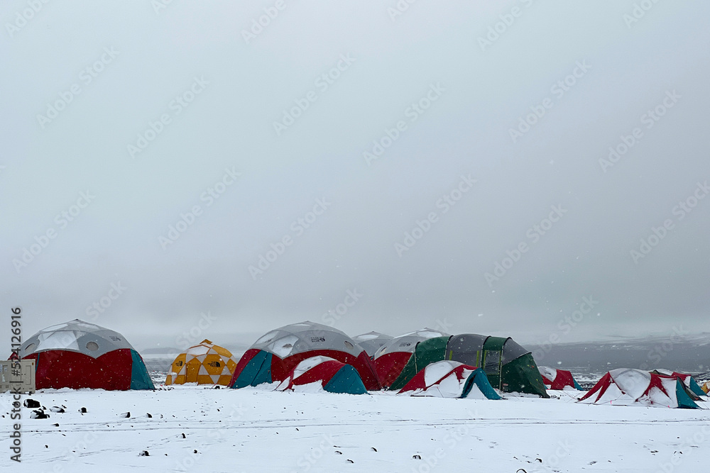 Snow covered campsite and tents of a scientific research expedition on ...
