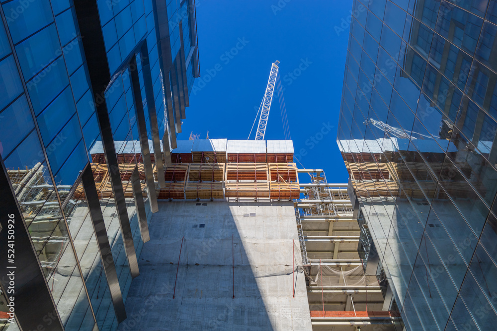 Construction of a high-rise building. Construction crane, scaffolding ...