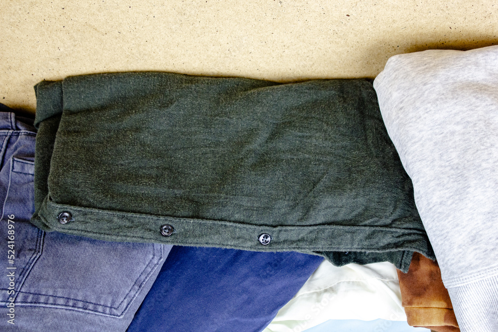 Clothes in a wooden box. Clothes in a drawer. Folded clothes, a stack ...