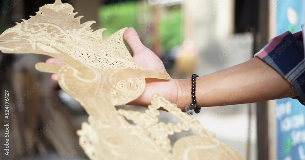 Youth hands showing processed shadow puppets. Wayang kulit is a ...