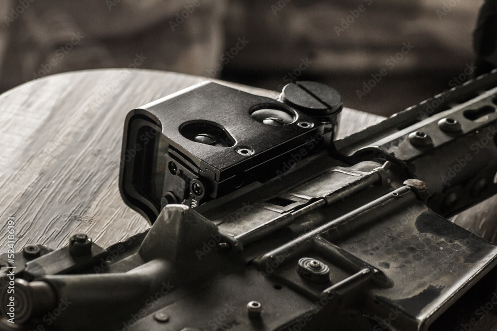 Close-up of flip rear sight and charging handle of assault rifle AR15 ...