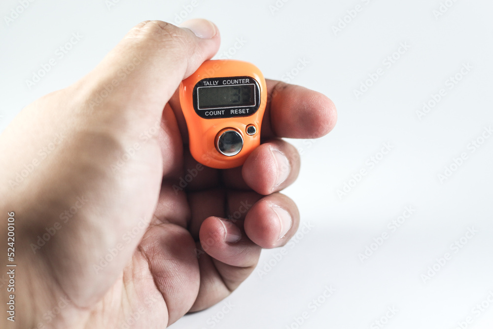 Hand holding numerical tasbih tally counter for islamic people to use ...