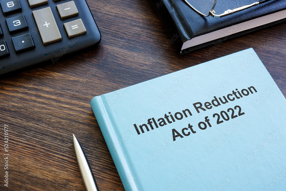 Book with The Inflation Reduction Act of 2022 near calculator and ...