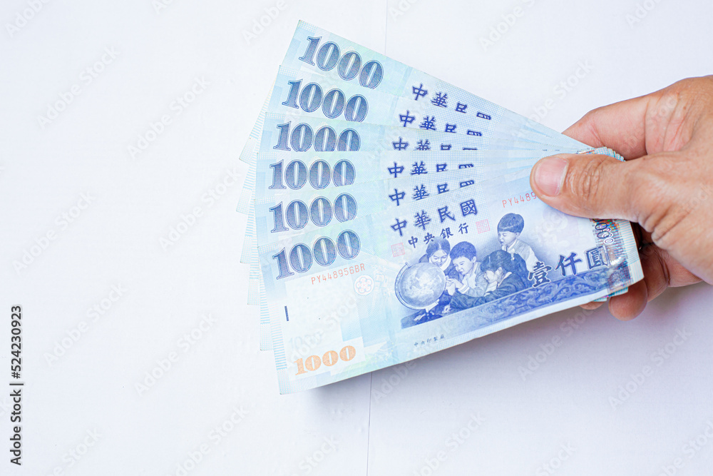 Human hand holding Taiwan money isolated on white background.Cash ...