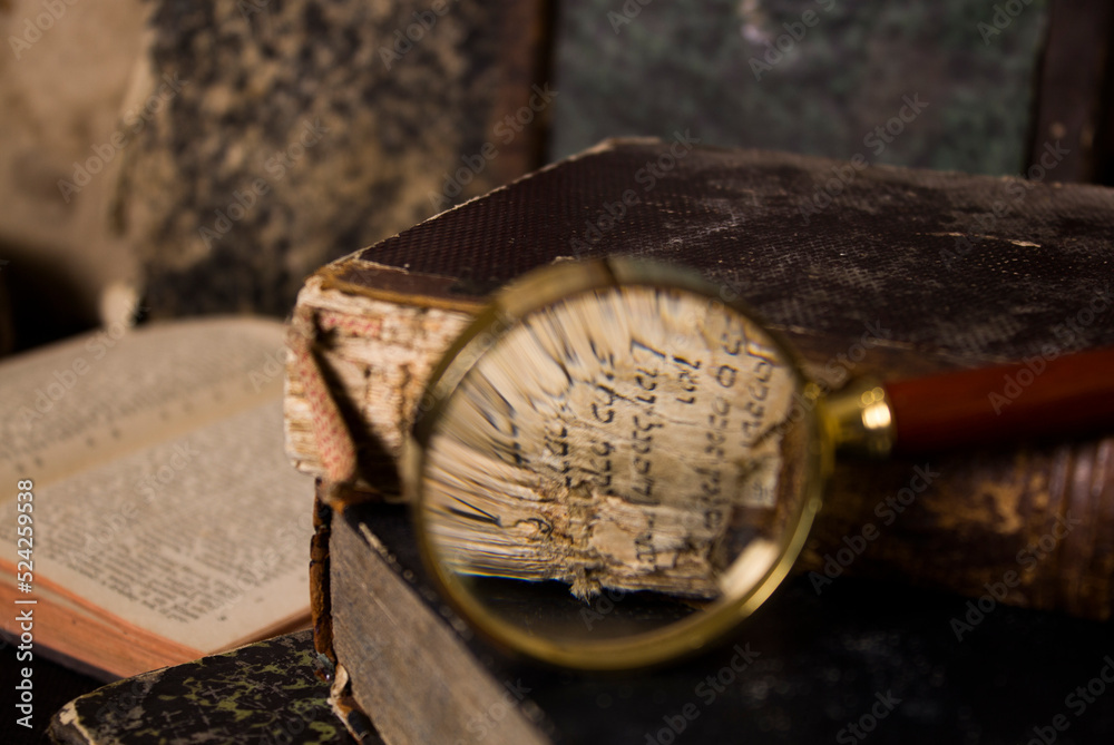 old books. examination with a magnifying glass. binding volumes Stock ...