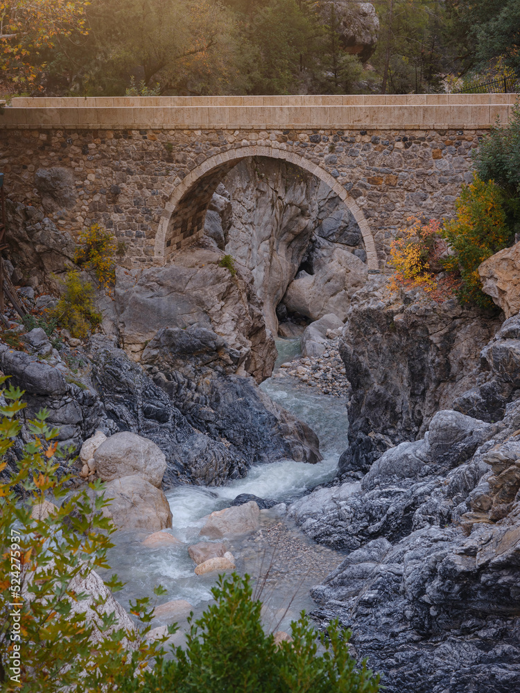 travel to Turkey, Kemer in autumn seasone. ancient Roman bridge over a ...