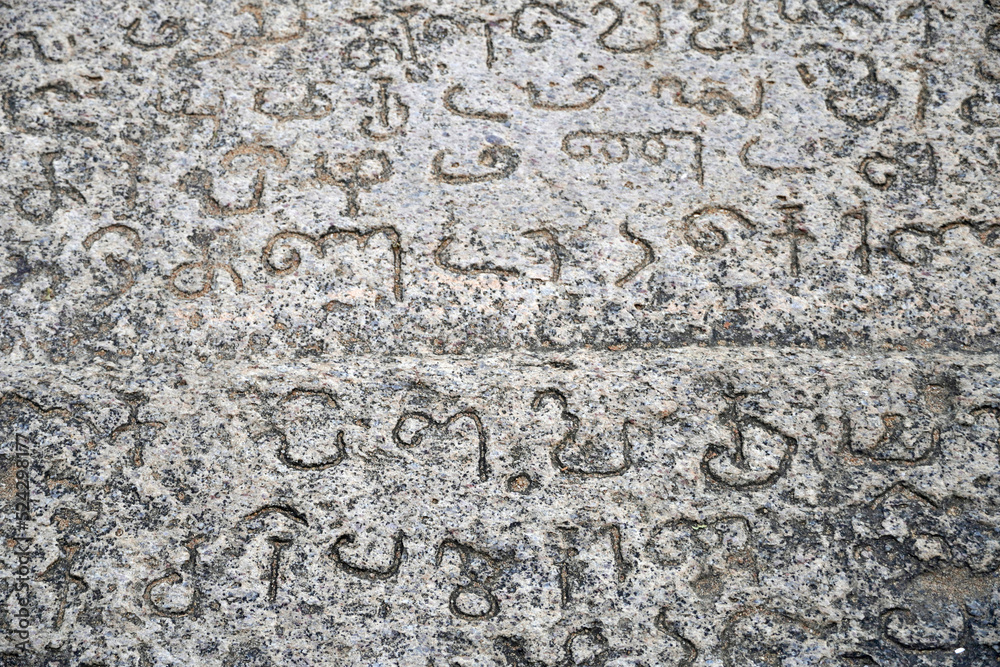 Inscriptions of ancient language carved on the stone walls at Hindu ...