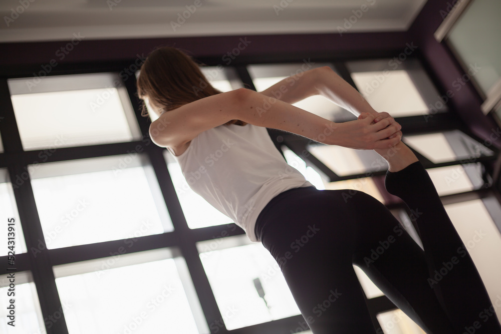 Slim girl doing gymnastic exercises Stock Photo | Adobe Stock