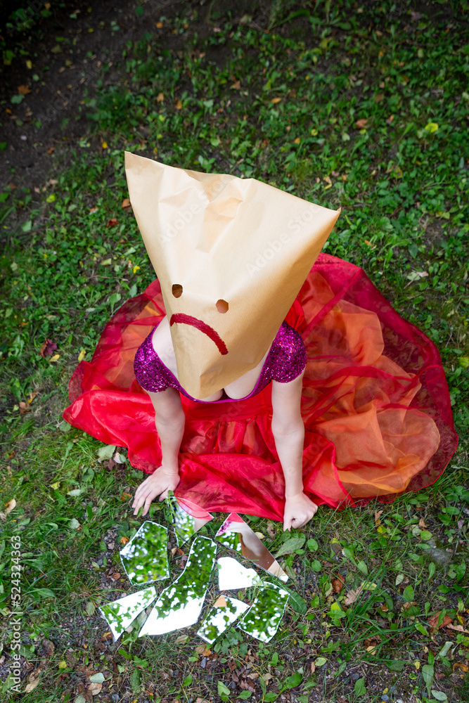 A young woman without a face is on her knees on the ground. A woman ...