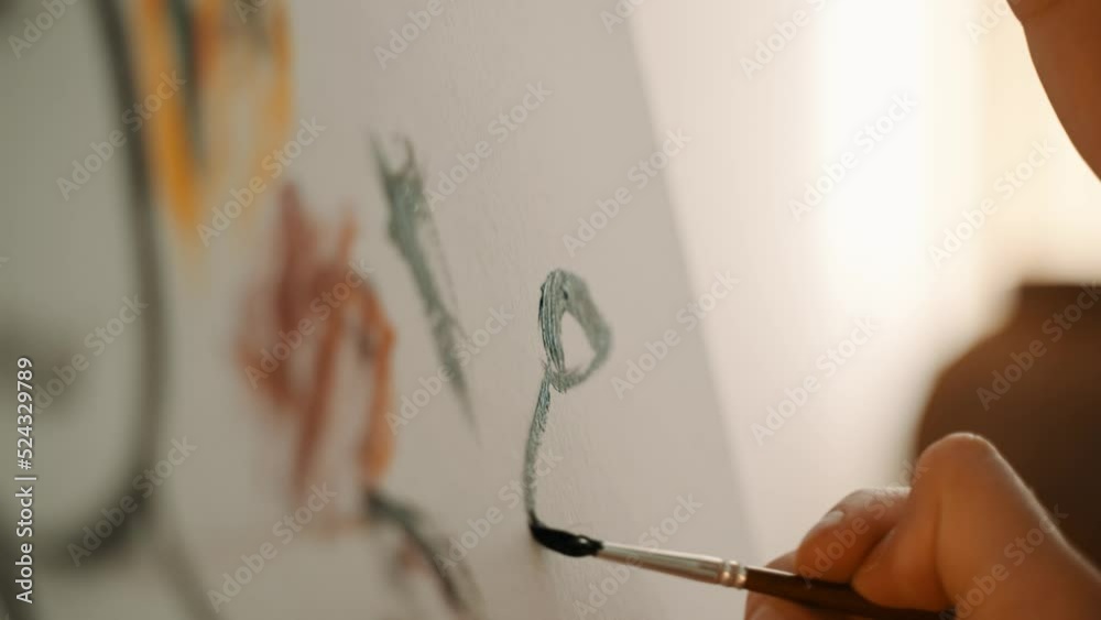 Drawing with two hands. A couple is drawing a picture. A man and woman ...