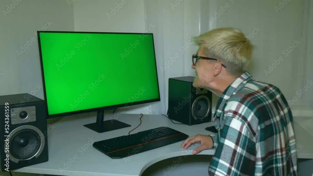 Guy is fooling around and threatening with his fist at the screen with ...