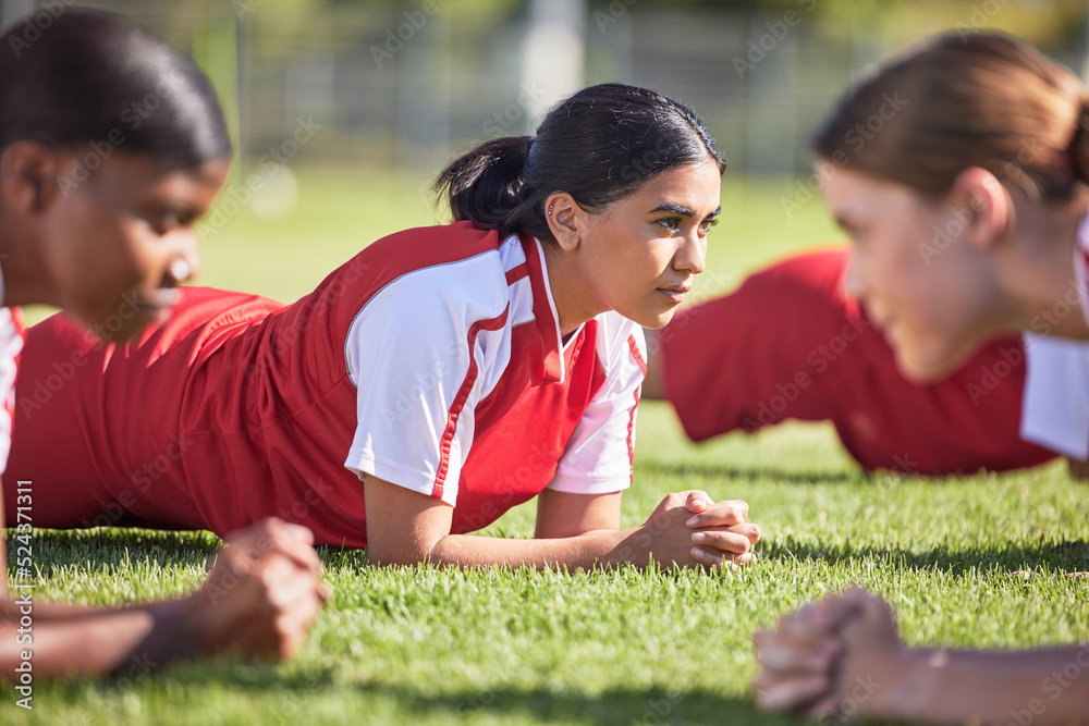 Women soccer players in a team doing the plank fitness exercise in ...