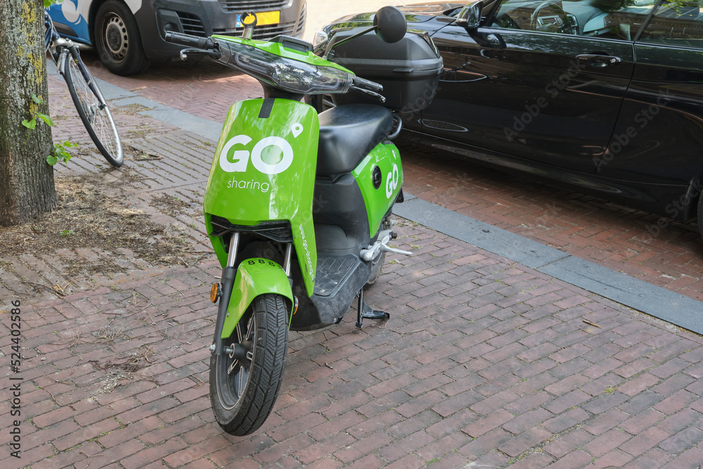 A green Go Sharing electrical scooter. GO Sharing is a micromobility ...