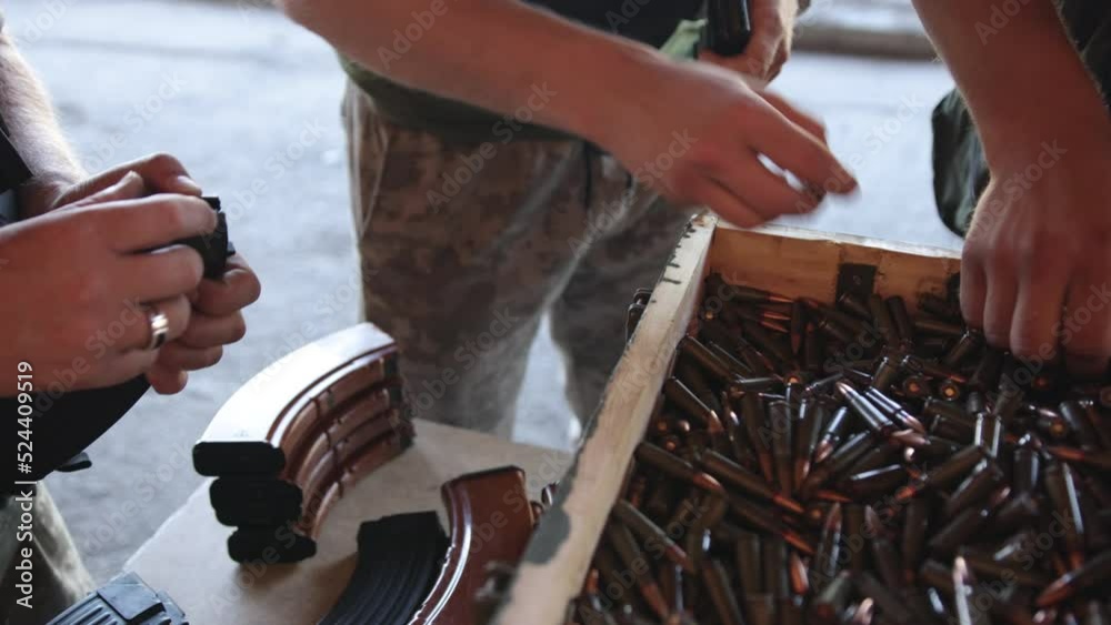 Close-up of hand taking ammo, 7.62 caliber bullets for the Ak47, war ... Close-up of hand taking ammo, 7.62 caliber bullets for the Ak47, war ...