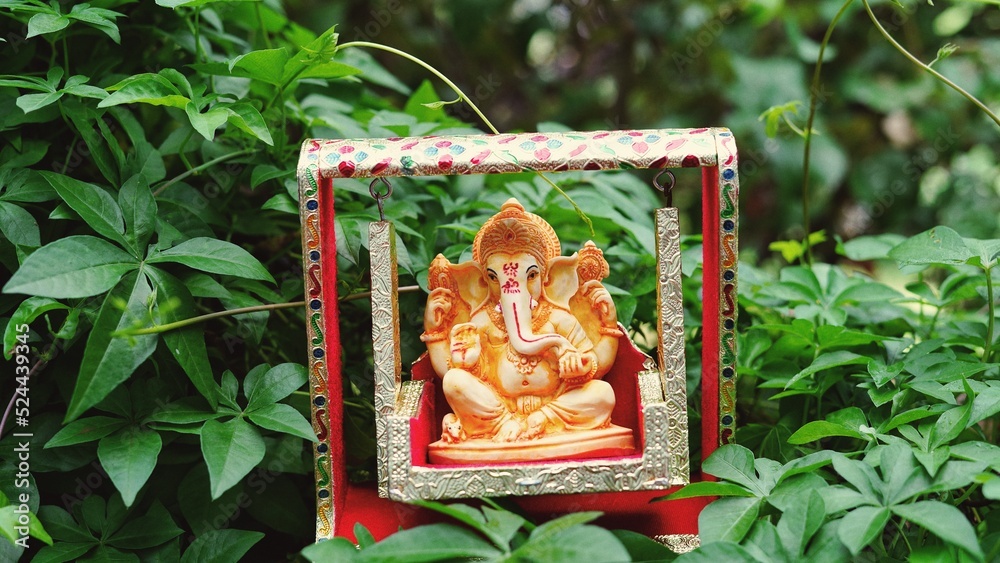 Lord Ganesha idol sitting in decorated swing in Ganesh Chaturthi ...