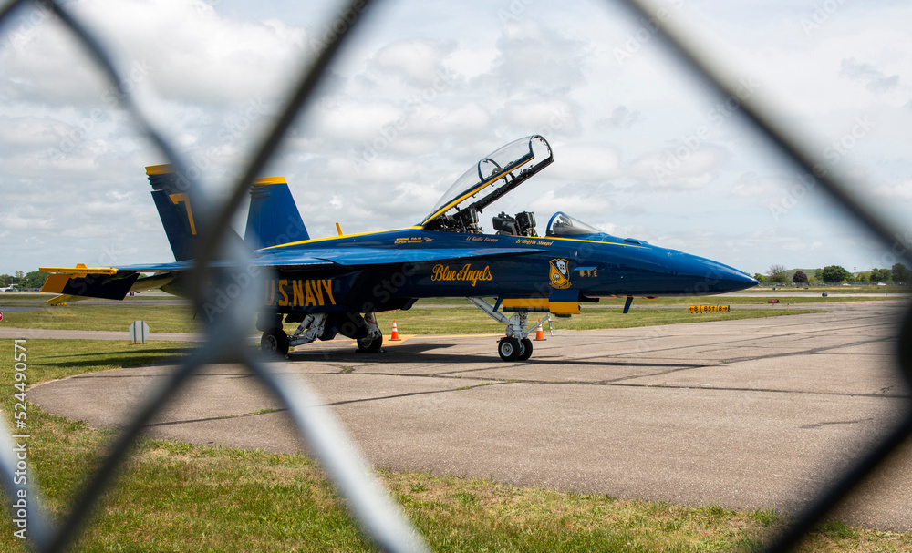 Looking through a fence at US Navy Blue Angels Jet with its cockpit ...