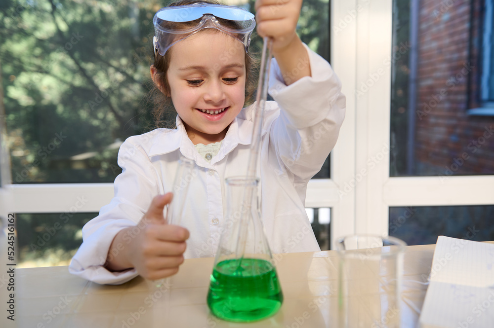 Excited mart kid, curious little girl, future chemist conducting a ...