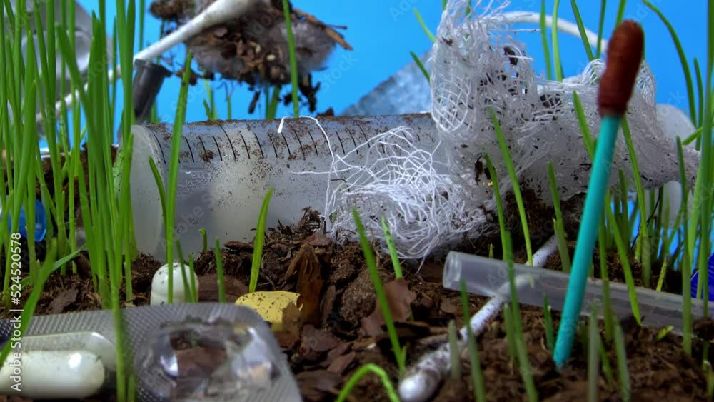 Polluted earth by used medical needles and bandages with ear sticks ...