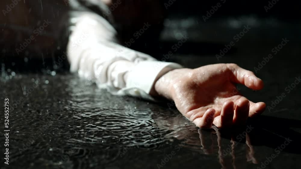 Video „dead man in puddle in rain in night, closeup view of hand, crime ...