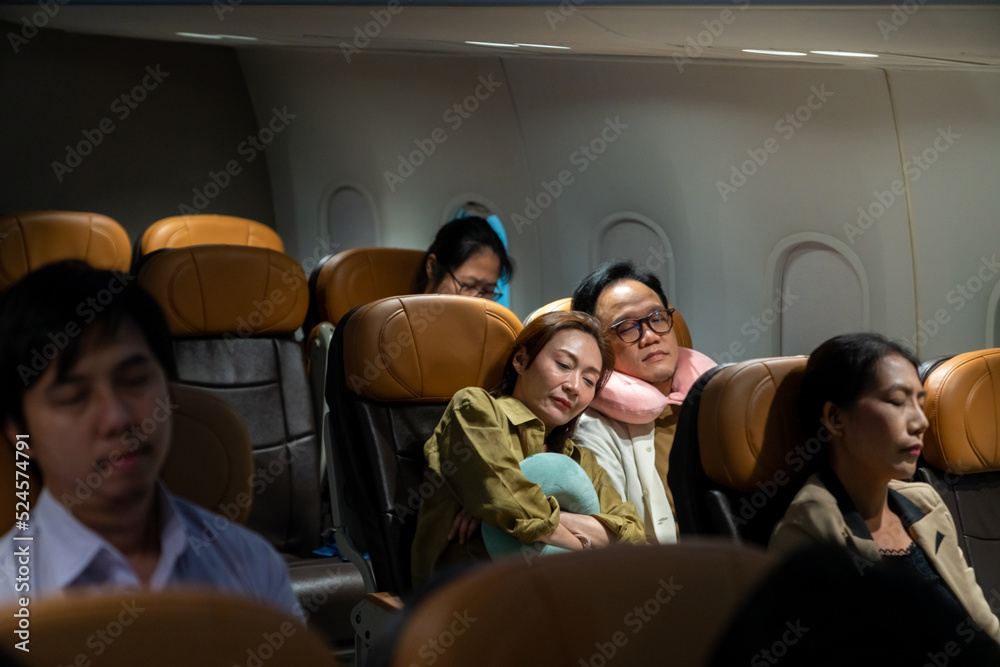 Asian couple travel on summer vacation by airplane. Husband embracing ...