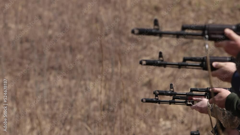 Using a machine gun, a men fires a shooting range target on a shooting ...