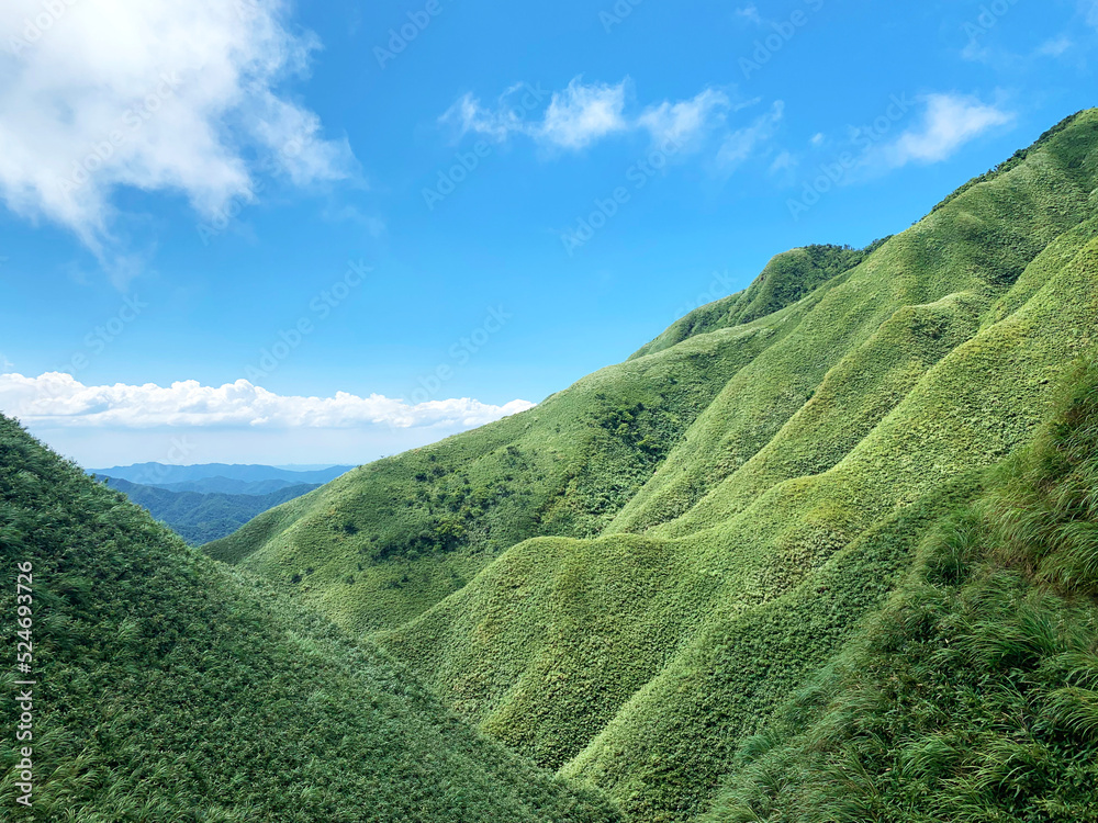 beautiful valley landscape view with blue sky and green mountain in ...