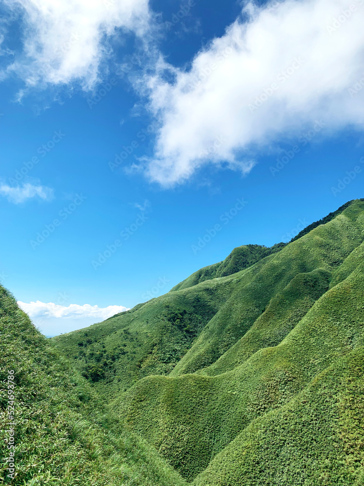 beautiful valley landscape view with blue sky and green mountain in ...