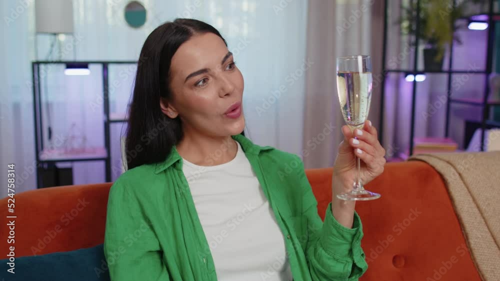 Happy caucasian girl hold glass of champagne cheering drinking ...