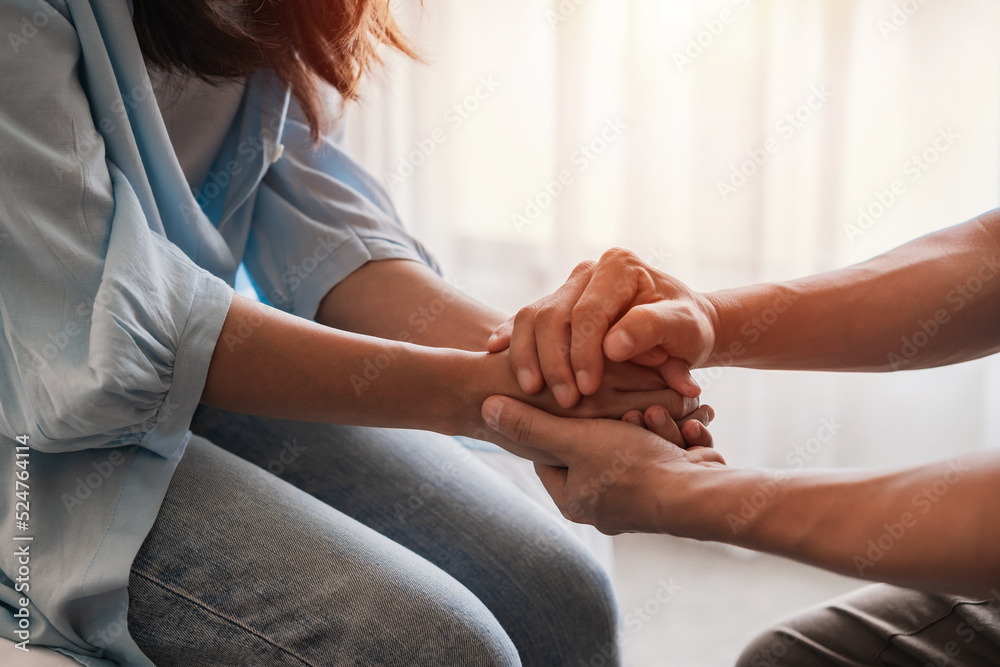 Young man comforting and supporting a sad woman who is in serious ...