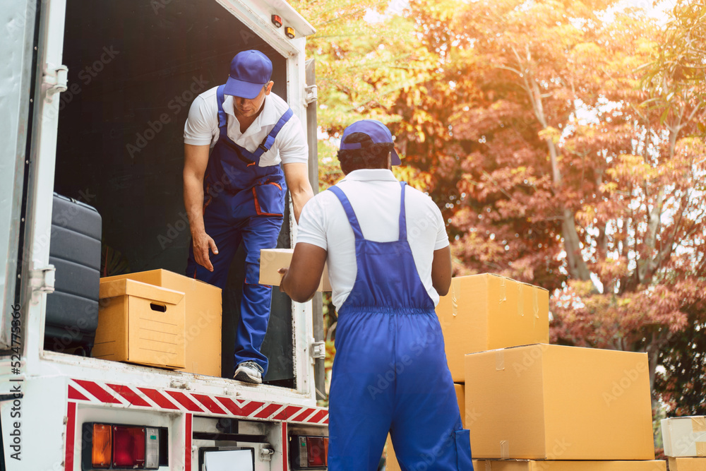 Couple courier house mover handover cardboard box in to the truck ...