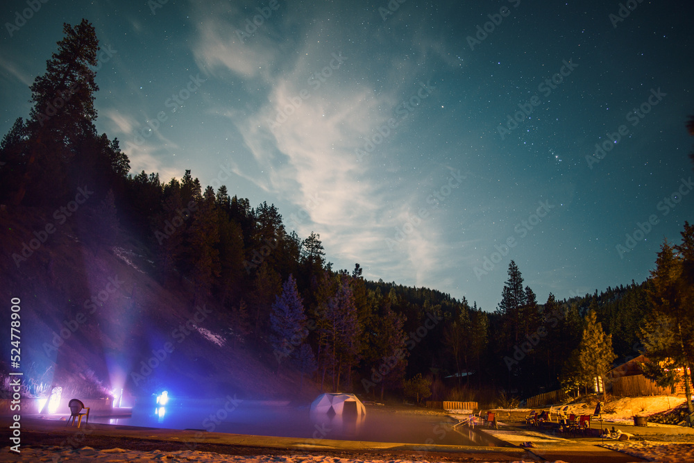 Hot springs with starry night sky overhead, mountain retreat ...