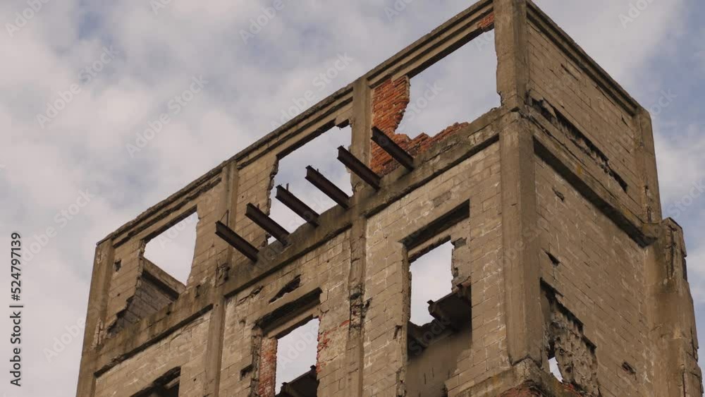Destroyed abandoned factory building with broken windows. Consequences ...