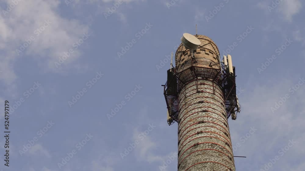 Top of industrial smoke pipe against the blue sky background. Factory ...