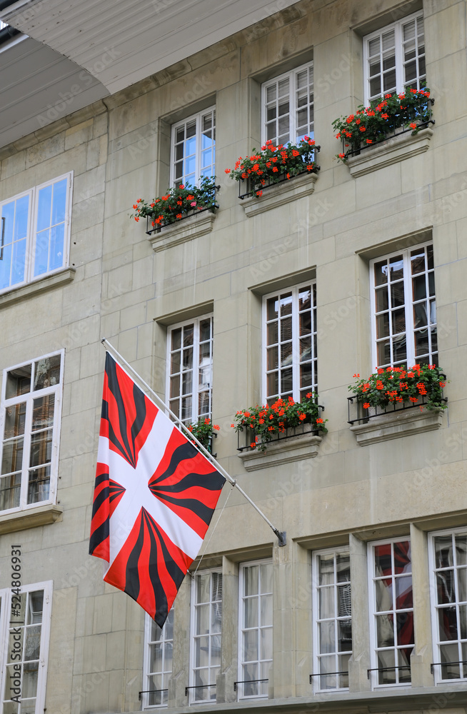 Old war flag of Bern (flag of the Ancien Regime) on grey wall of house ...