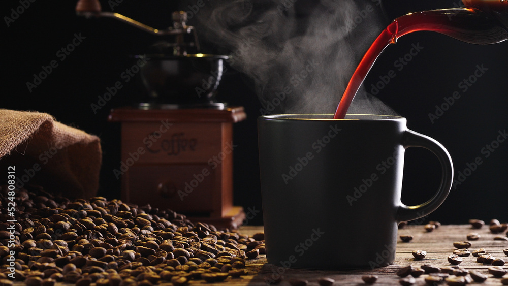 Pouring hot coffee into coffee cup, mug with vintage grinder espresso ...