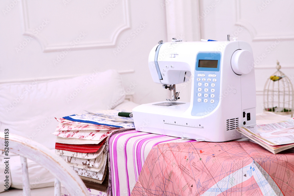 Composition from a sewing machine. Mannequin, flowers on a retro table ...