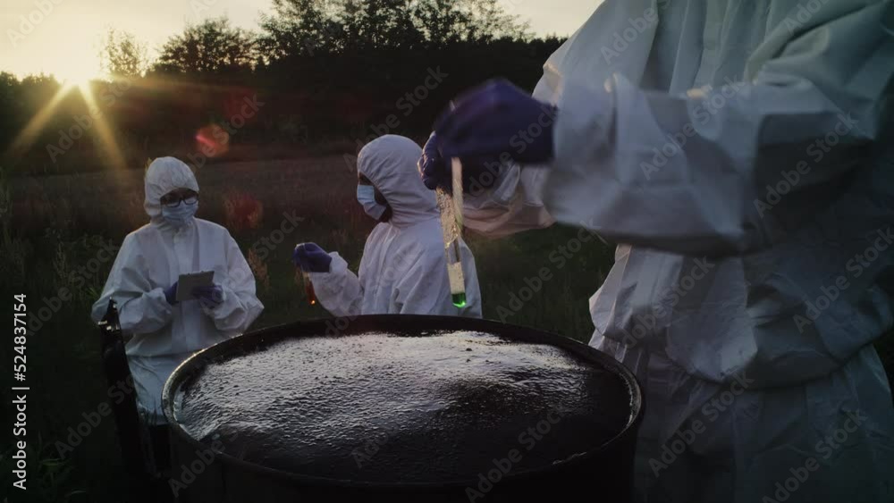 Scientists picking biohazardous samples in the infected area. Wearing ...