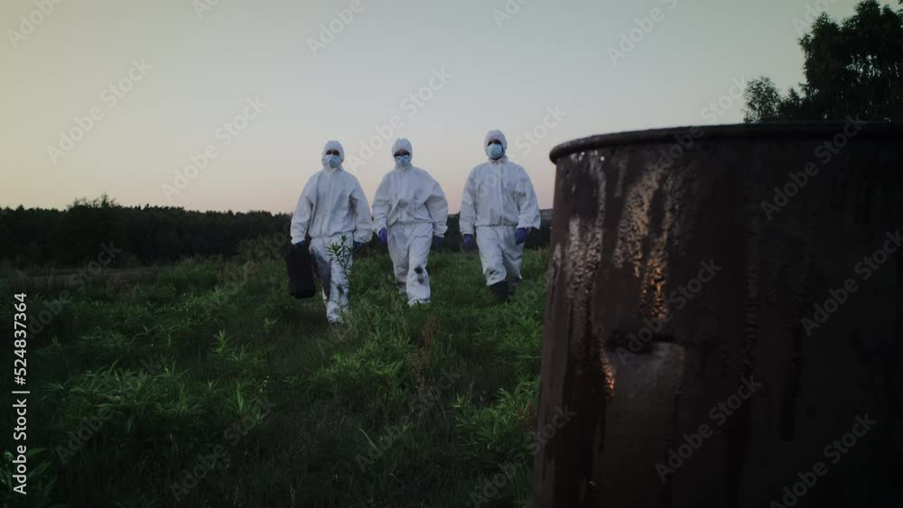 Scientists picking biohazardous samples in the infected area. Wearing ...