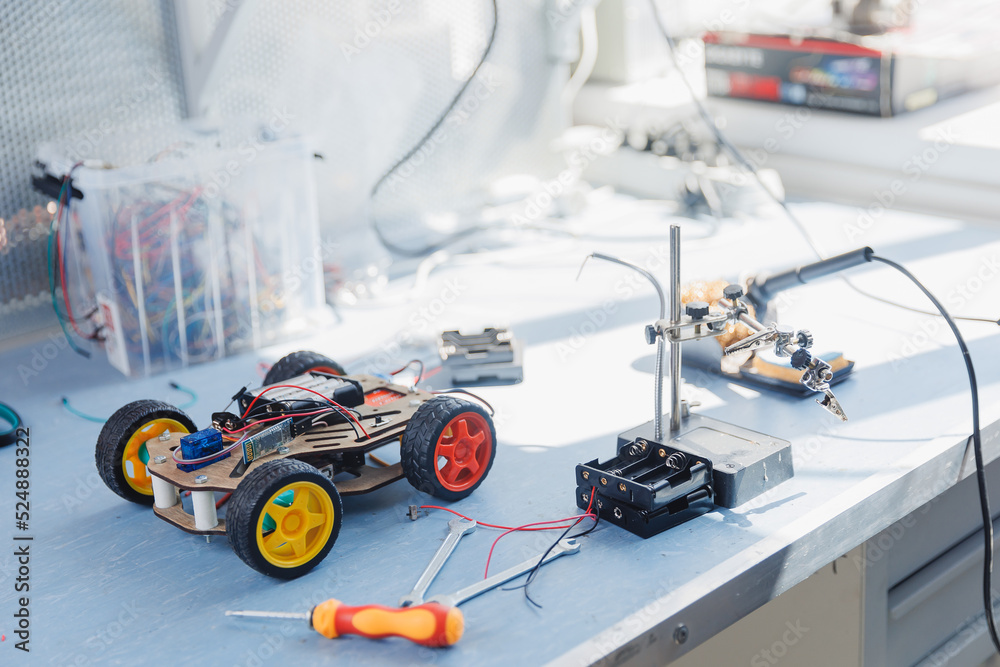 Professional workplace repair shop of toy RC models of cars and robots ...