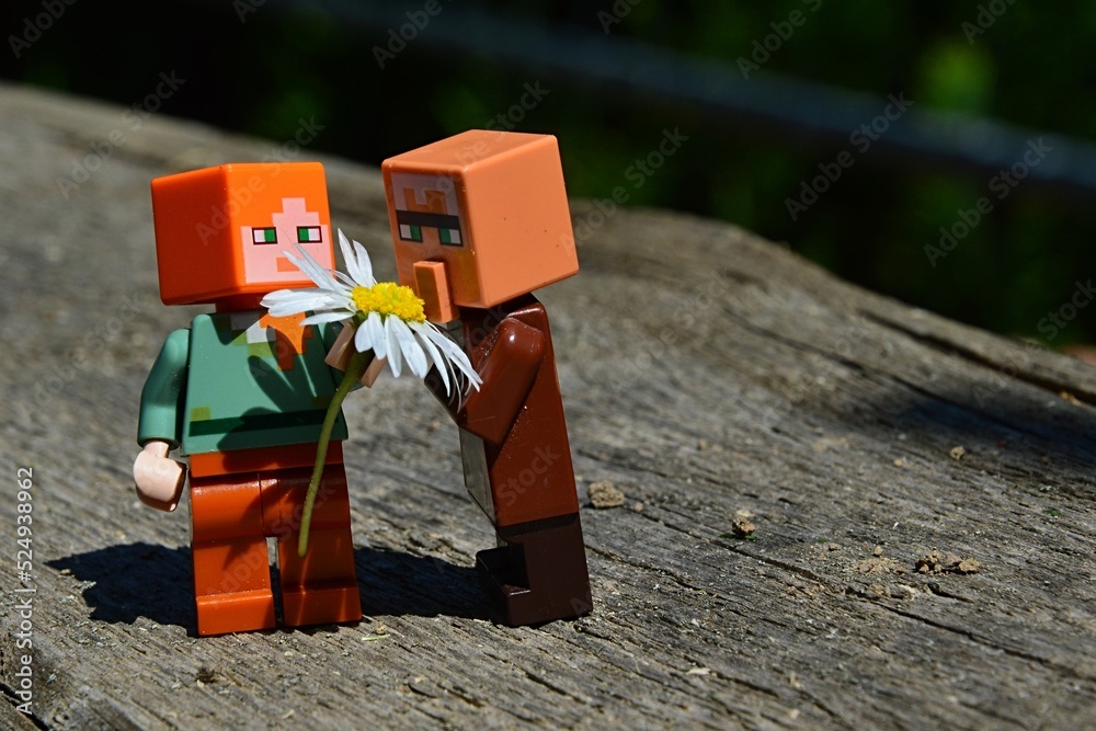 LEGO Minecraft figures of villager mob and Alex smelling yellow and ...