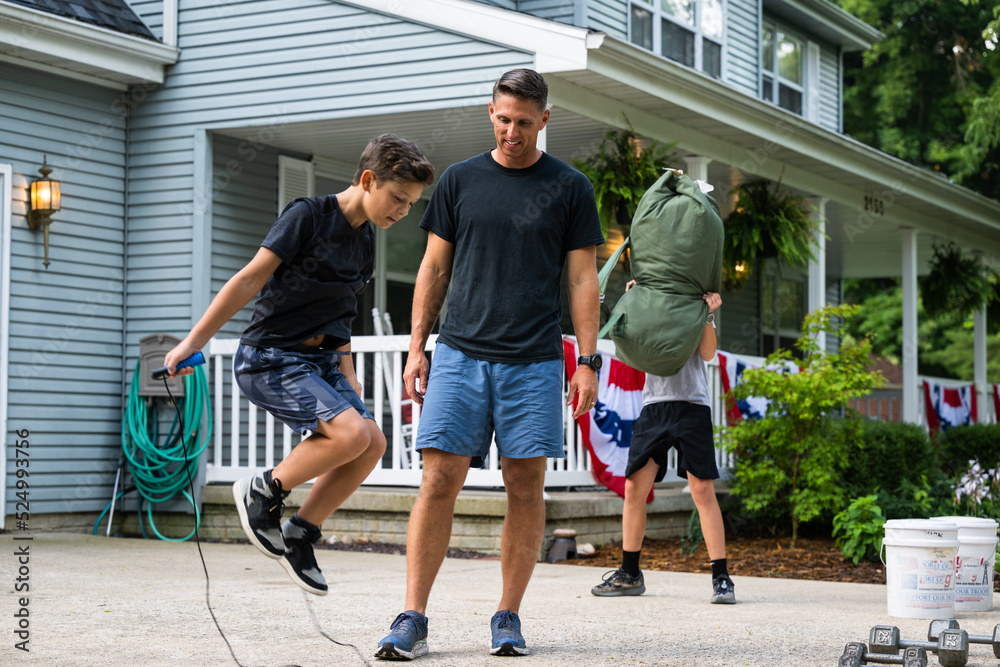 Air Force service member trains with his sons in a morning workout in ...