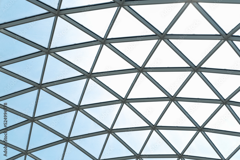 Architectural glass structure with a geometric triangular pattern on a ...