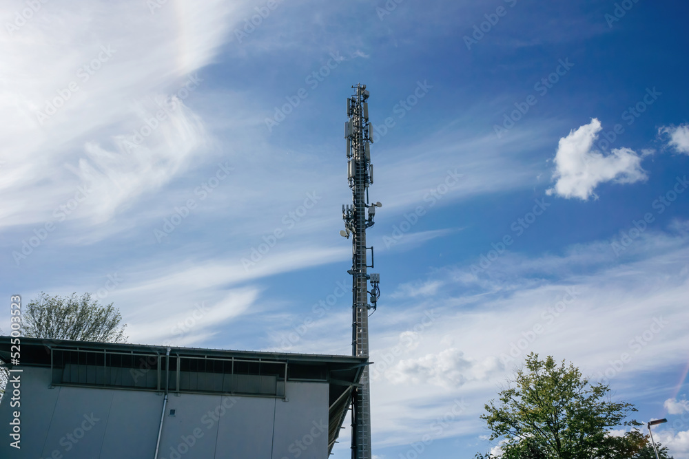 Tall 5G 4G LTE antenna tower mast against blue sky Stock Photo | Adobe Stock