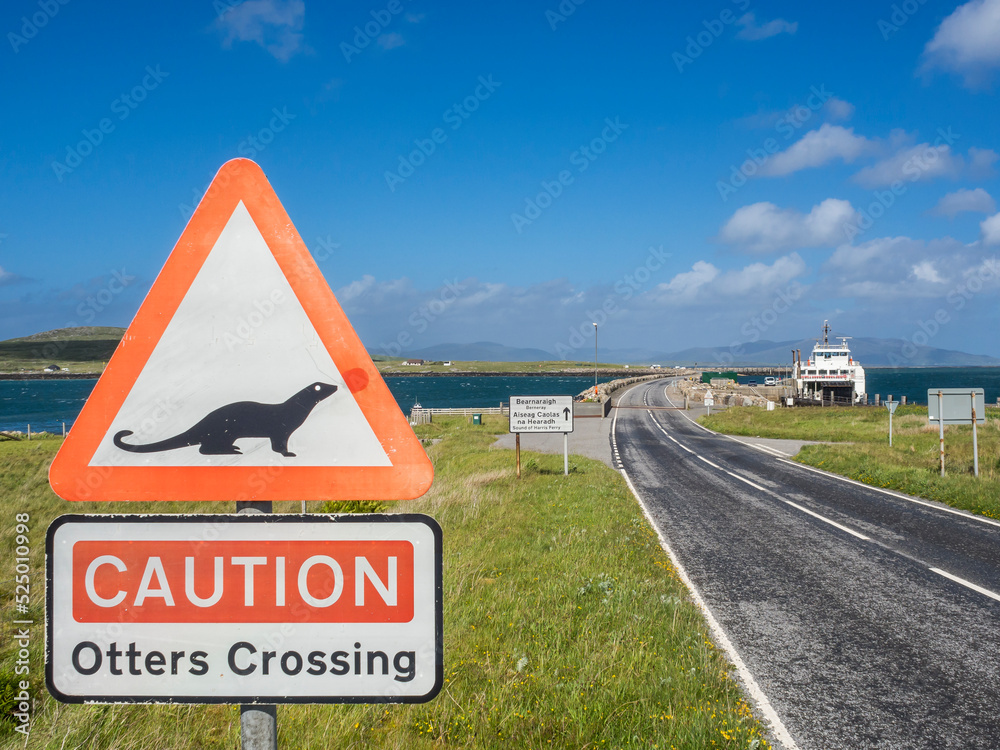 UK, Scotland,Otter crossing sign standing beside asphalt road in Outer ...
