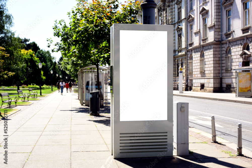 empty white billboard, ad panel and lightbox. urban setting with green ...