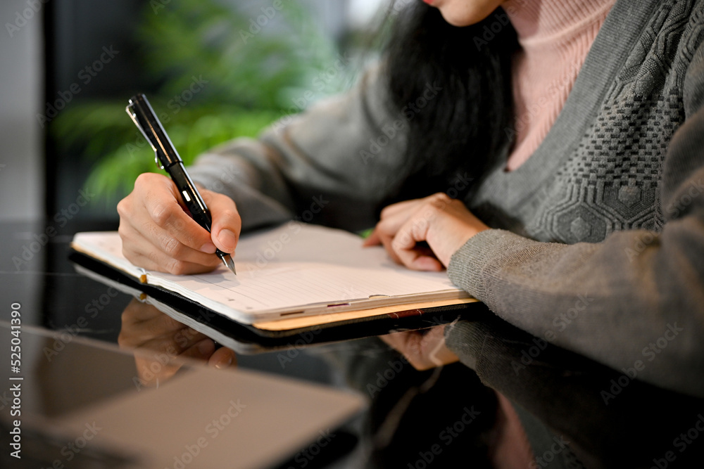 Female writing something on her diary. A female college student doing ...