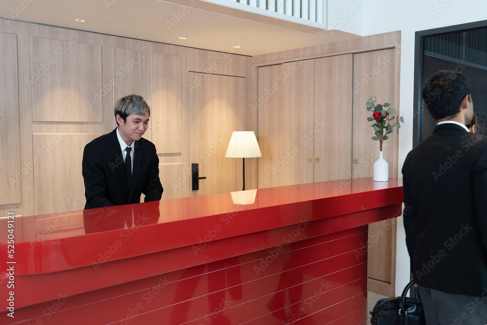 In the hotel lobby guest reception counter front desk staff greeting ...