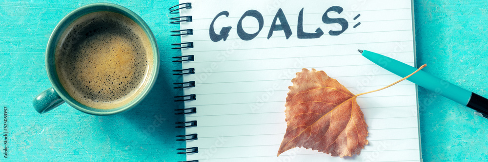 Autumn Goals panorama with the handwritten word in a notepad, a cup of ...